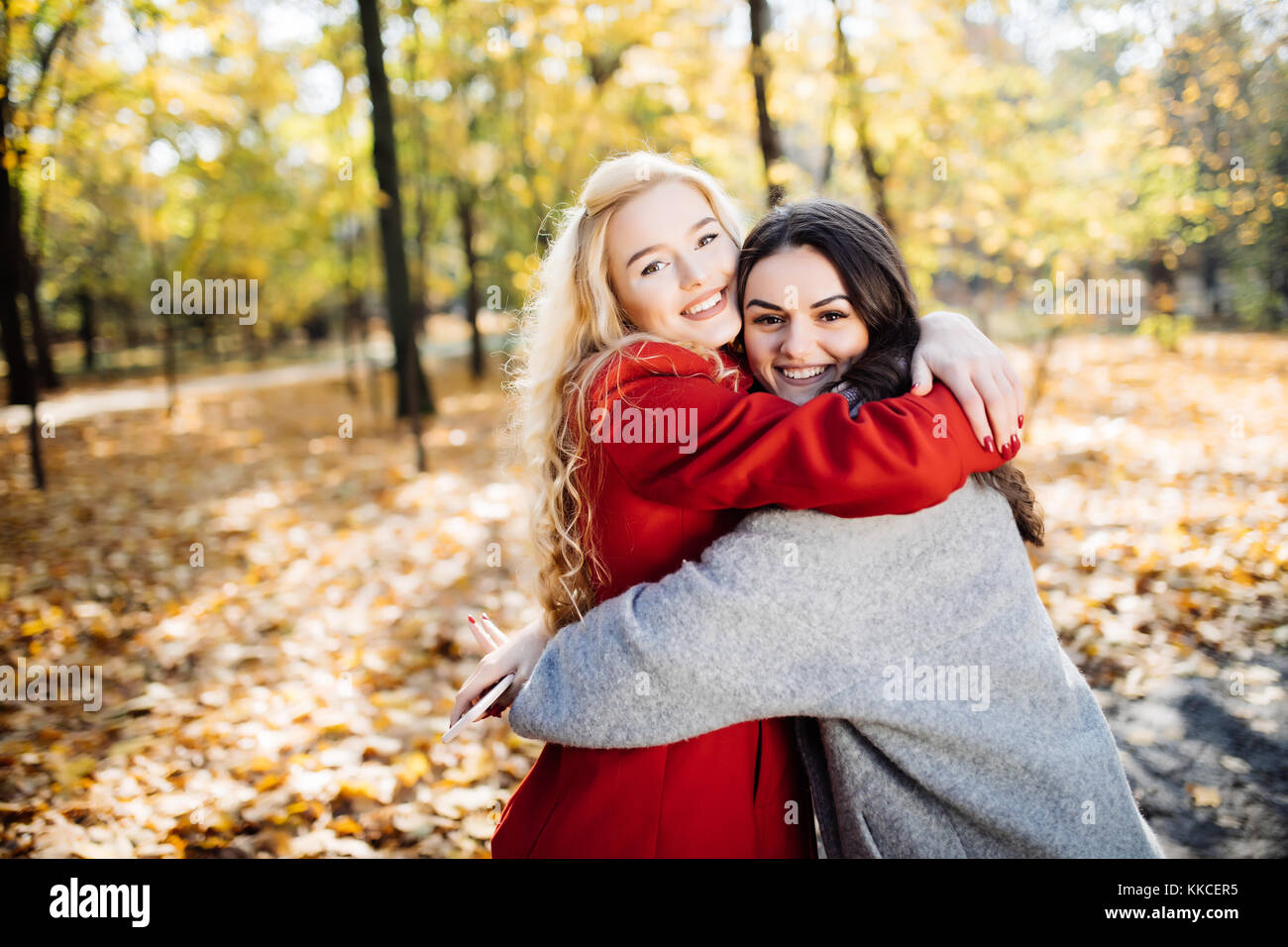 Girl hugging her best friend. In the park Stock Photo - Alamy