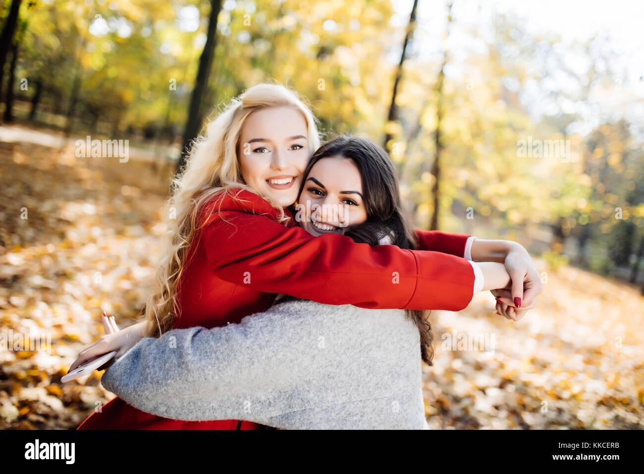 Girl hugging her best friend. In the park Stock Photo - Alamy Girl hugging her best friend. In the park Stock Photo - Alamy