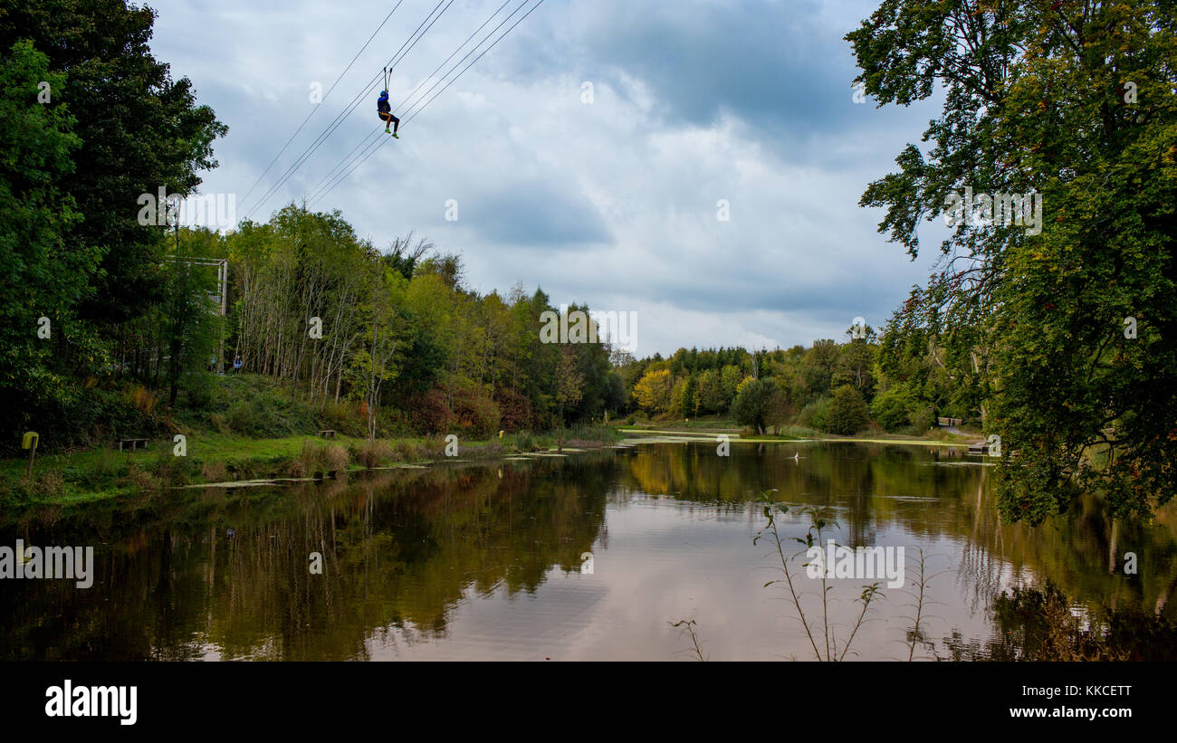 Man sliding on the longest over-water zipline in Ireland overlooking ...