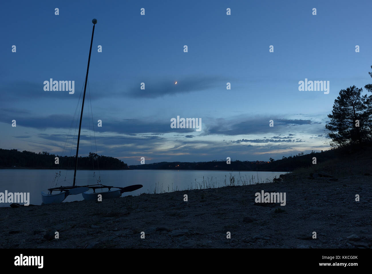 Boat on lake shore at night Stock Photo - Alamy