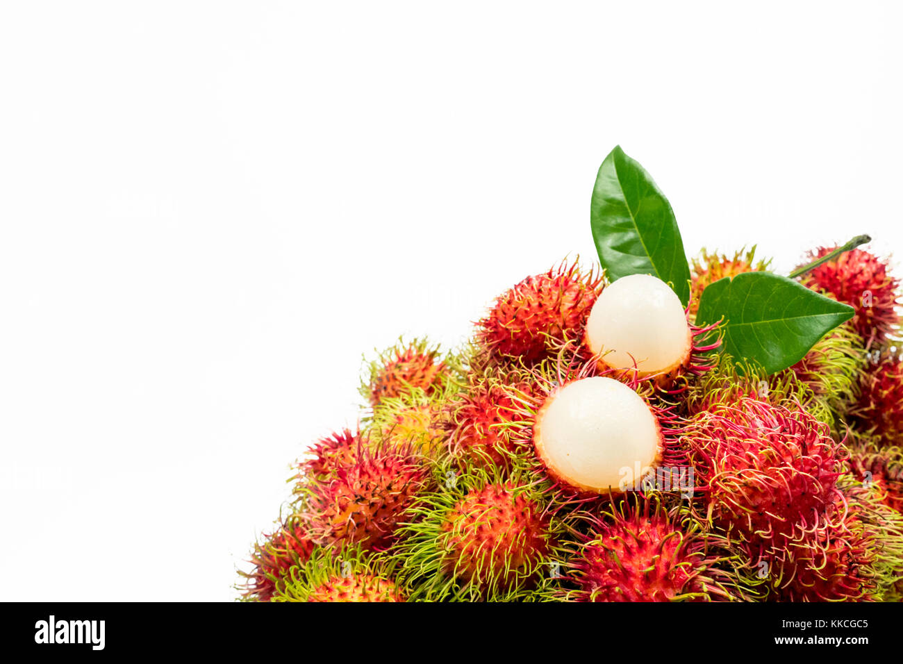 Closeup of fresh red ripe rambutan (Nephelium lappaceum) with leaves ...