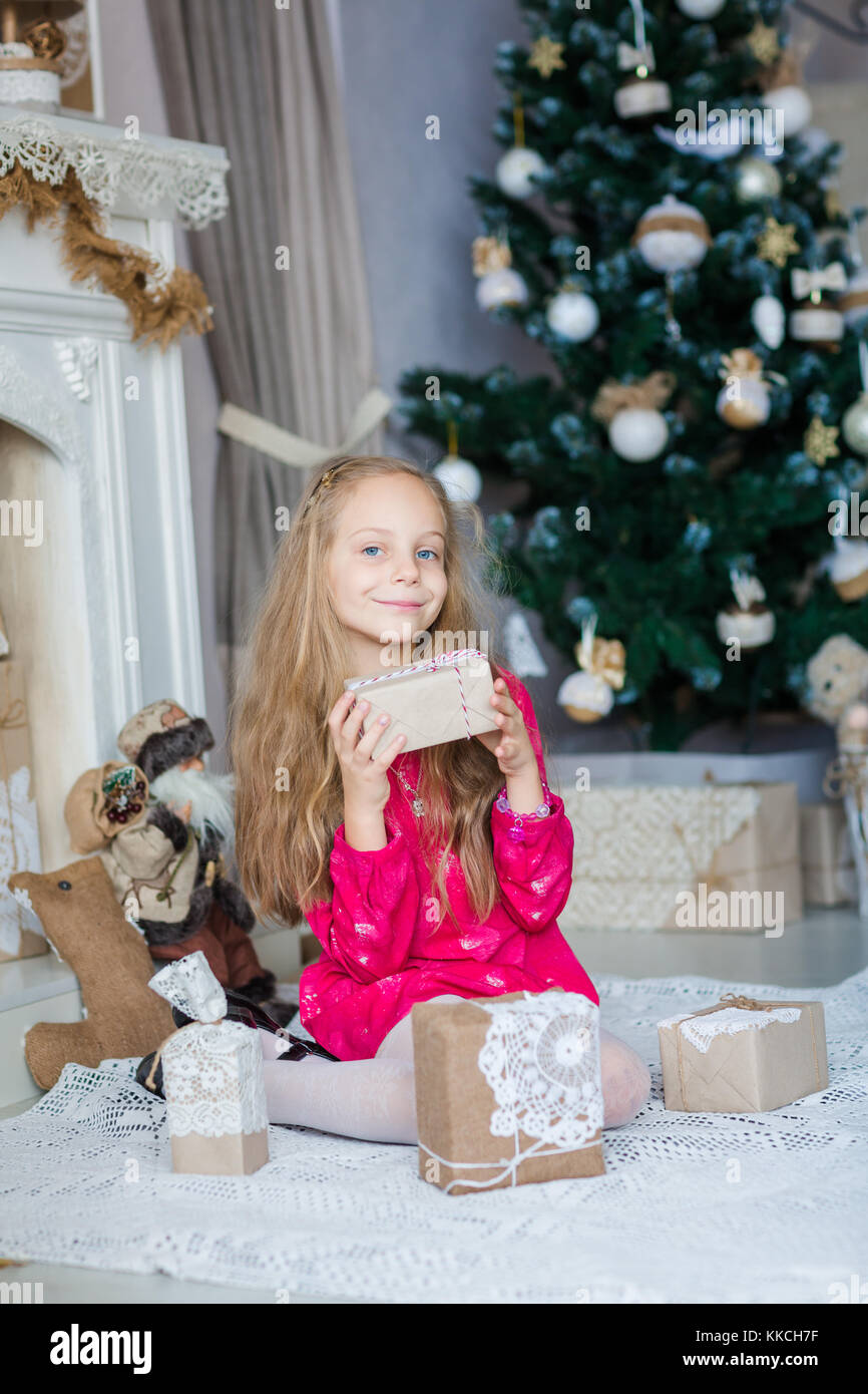 Happy little girl near Xmas tree Stock Photo - Alamy