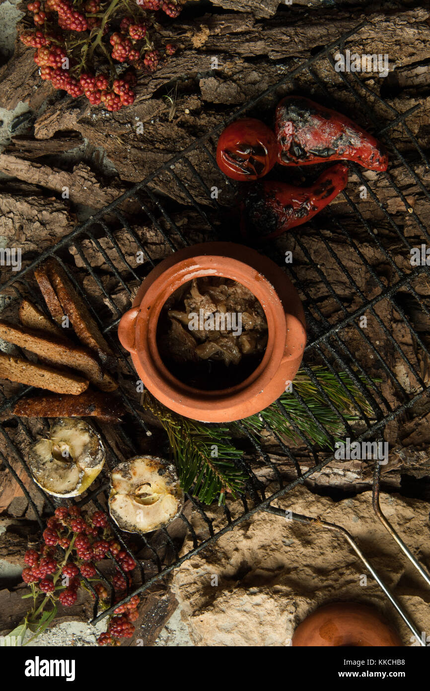 vegetarian dish in a clay pot with roasted vegetables on the grill on a ...