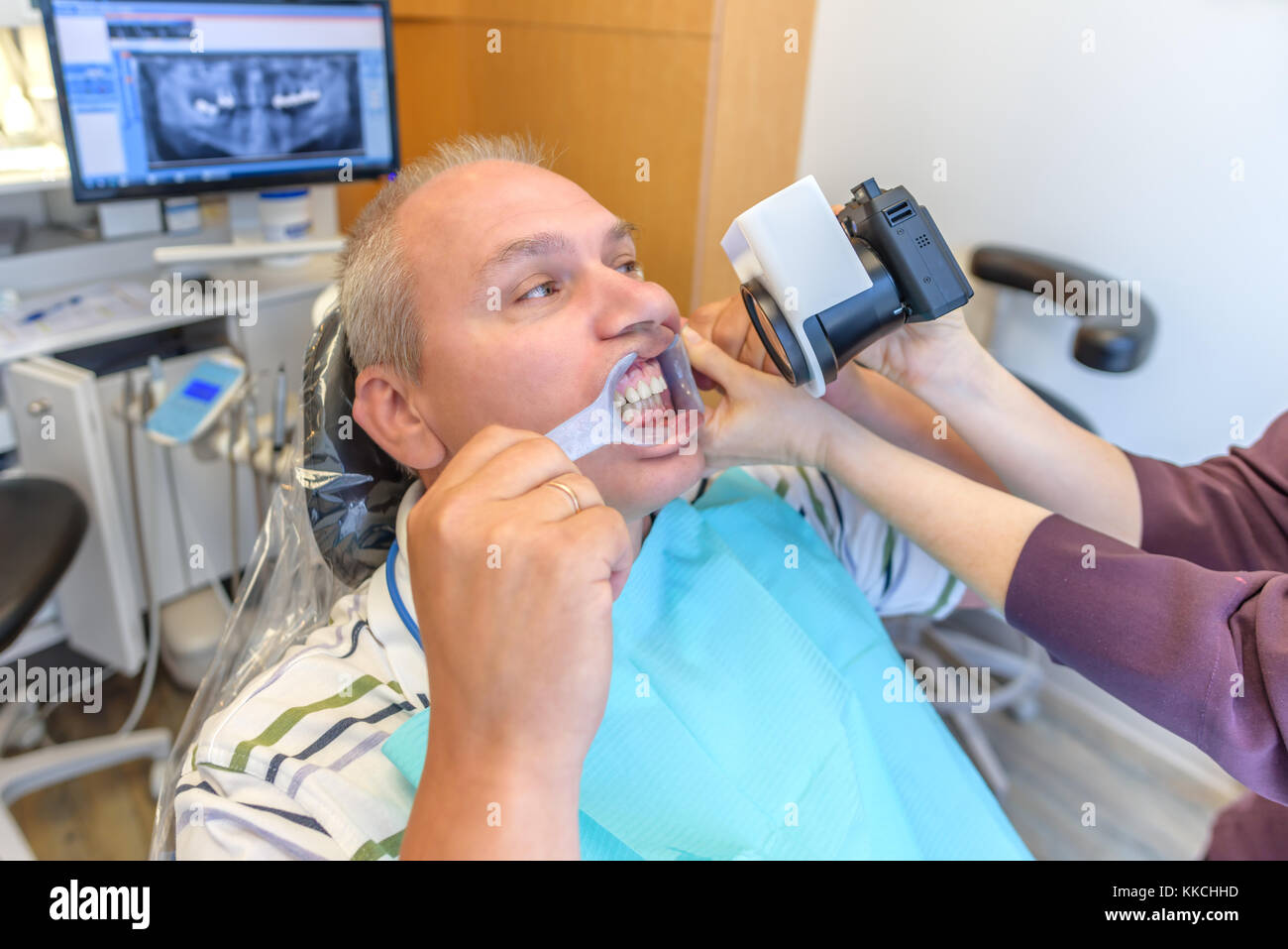 In the dentist's office, the doctor takes photographs of the patient's ...