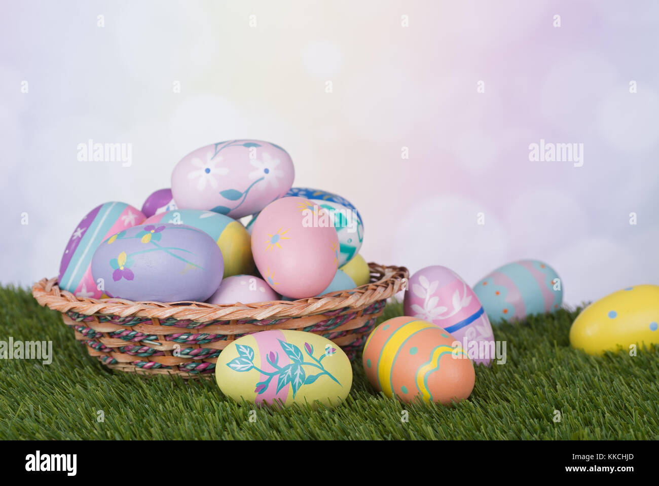 Easter eggs and basket on grass with colorful background Stock Photo ...