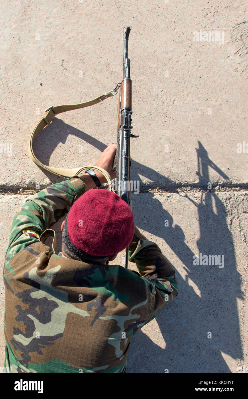 A Peshmerga soldier provides security during react to fire training at ...