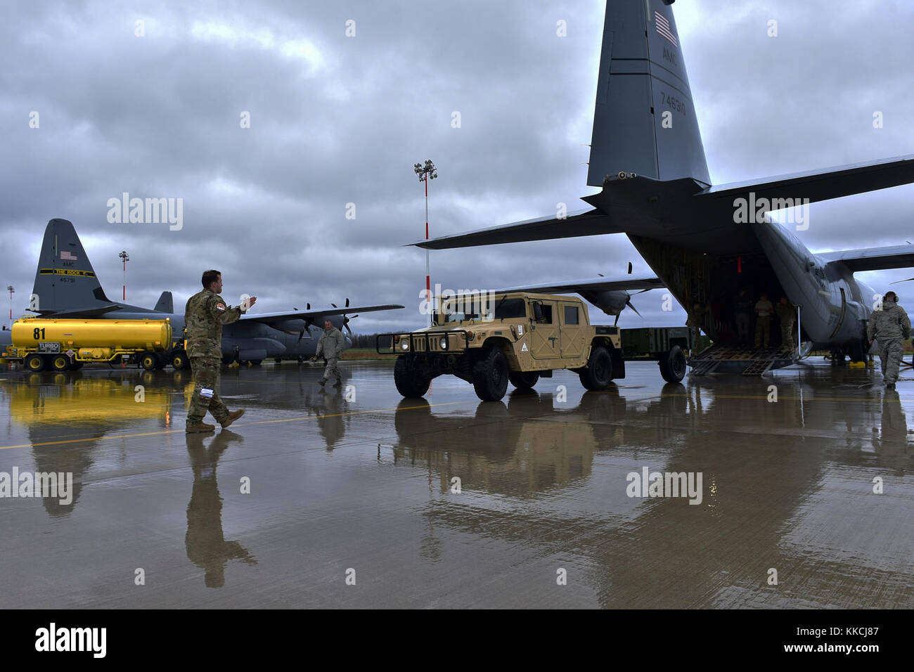 Little Rock Air Force Base Airman load a HUMVEE and trailer onto a C ...