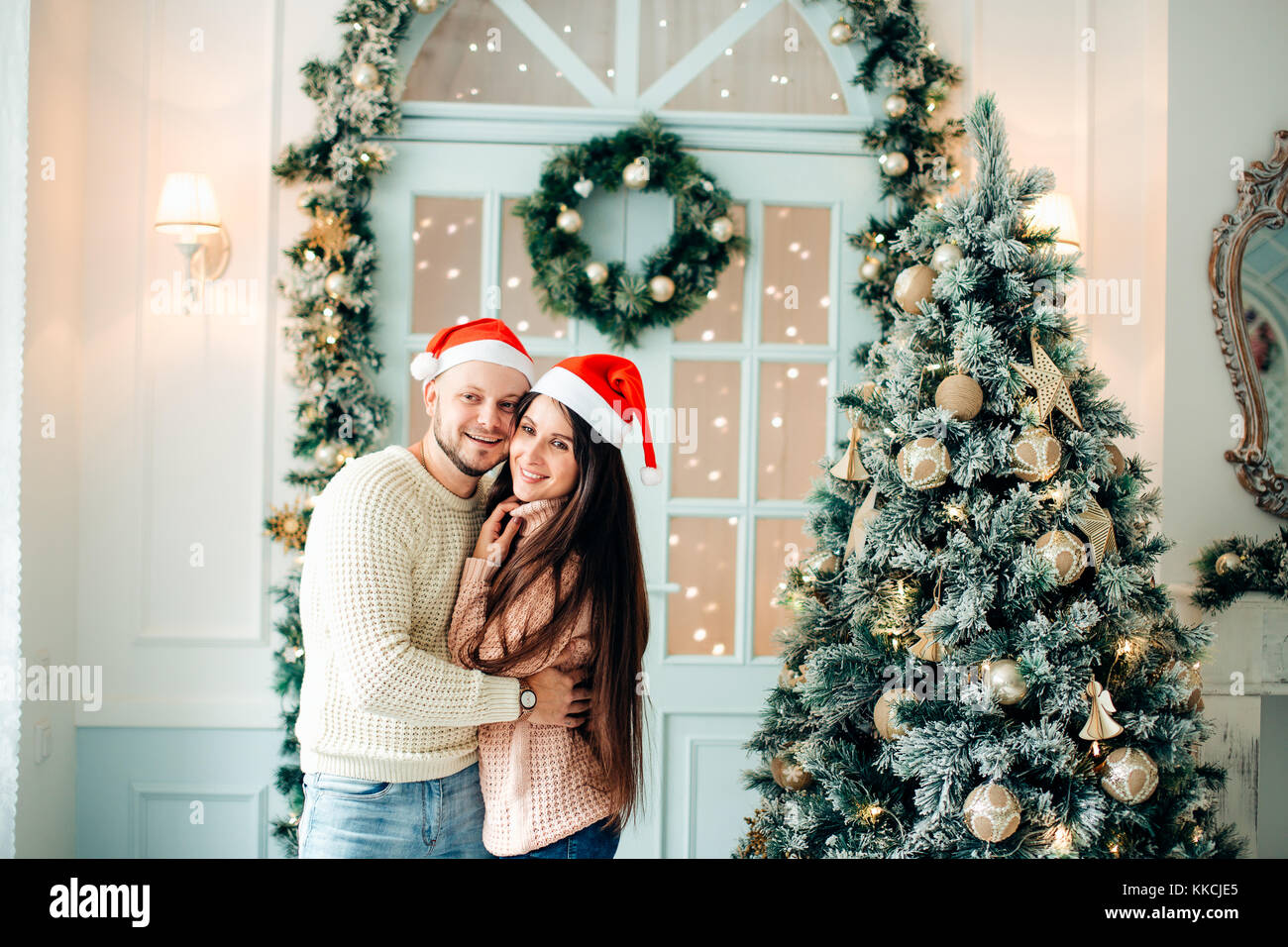 Couple celebrating Christmas together at christmas tree background ...