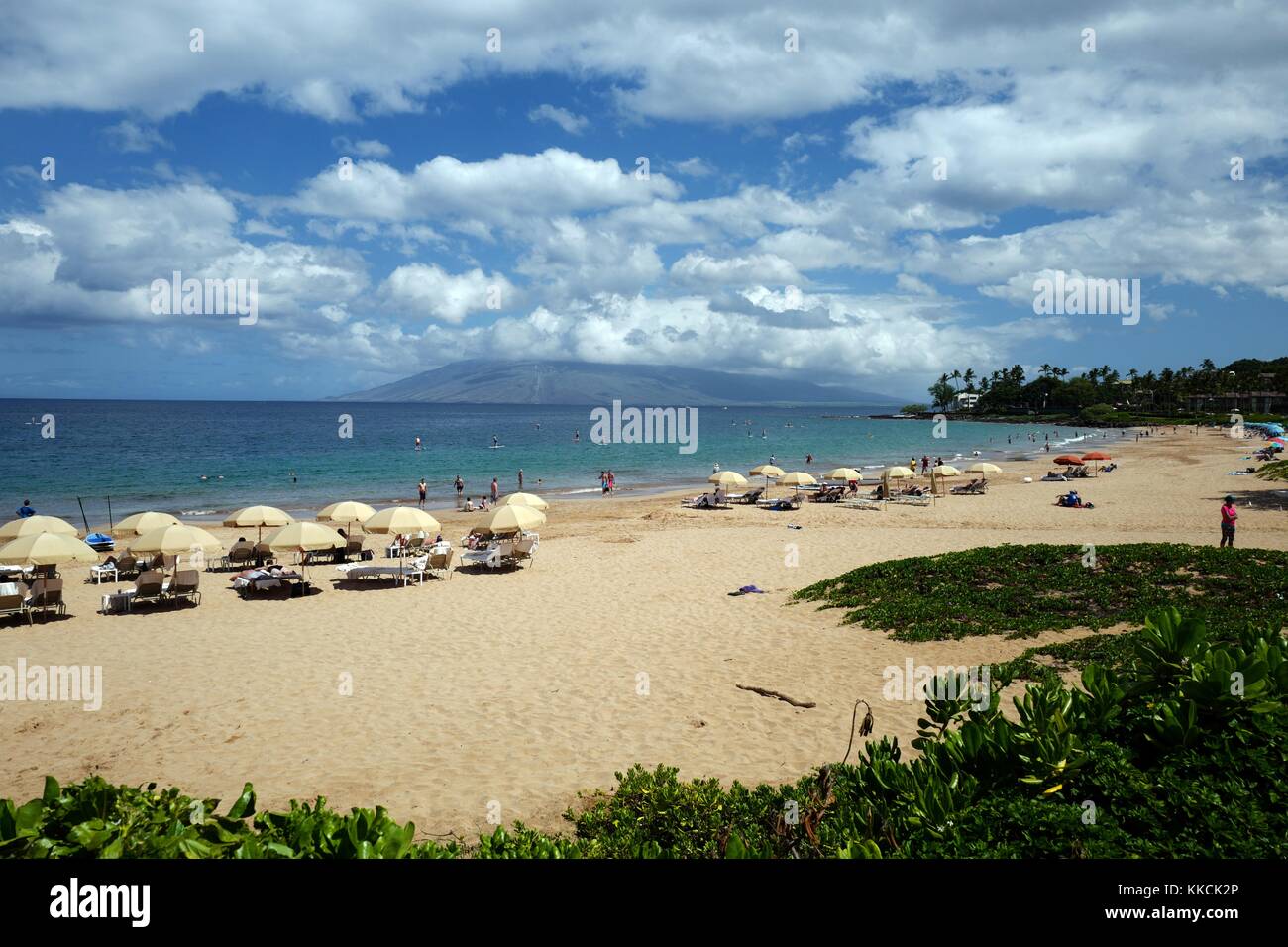 Wailea beach on a sunny day, with tourists sheltering under beach ...