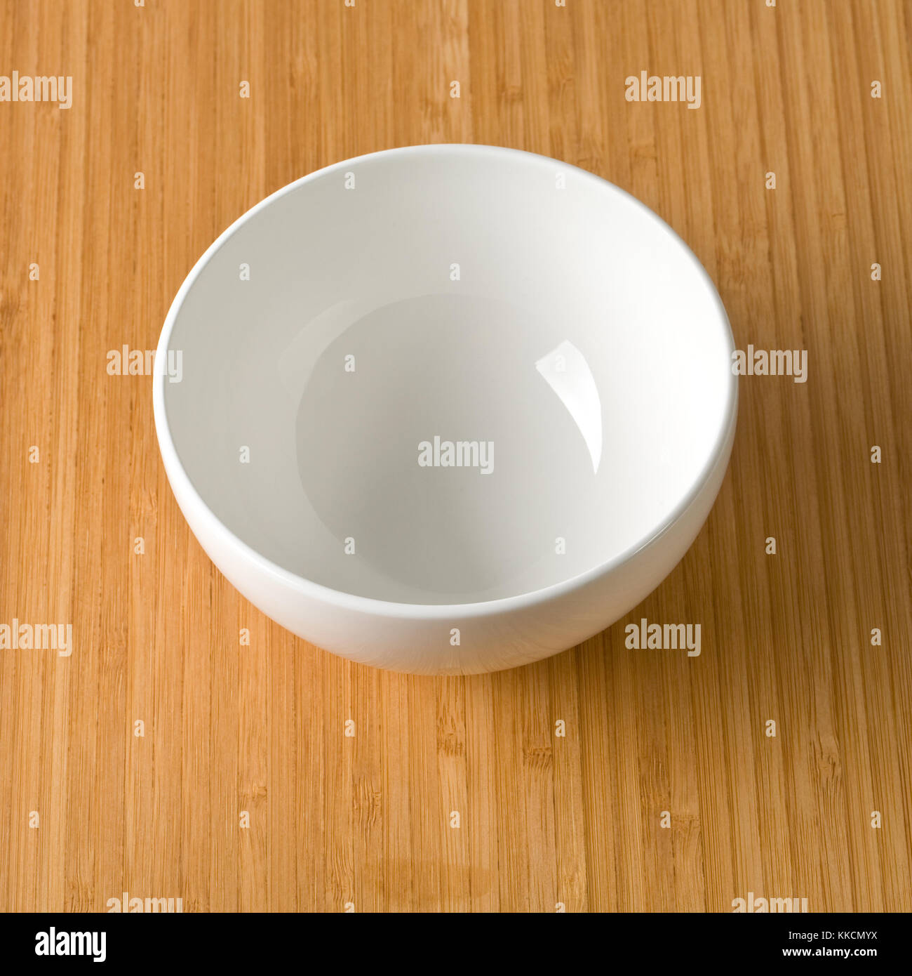 white empty bowl on a bamboo table top Stock Photo - Alamy