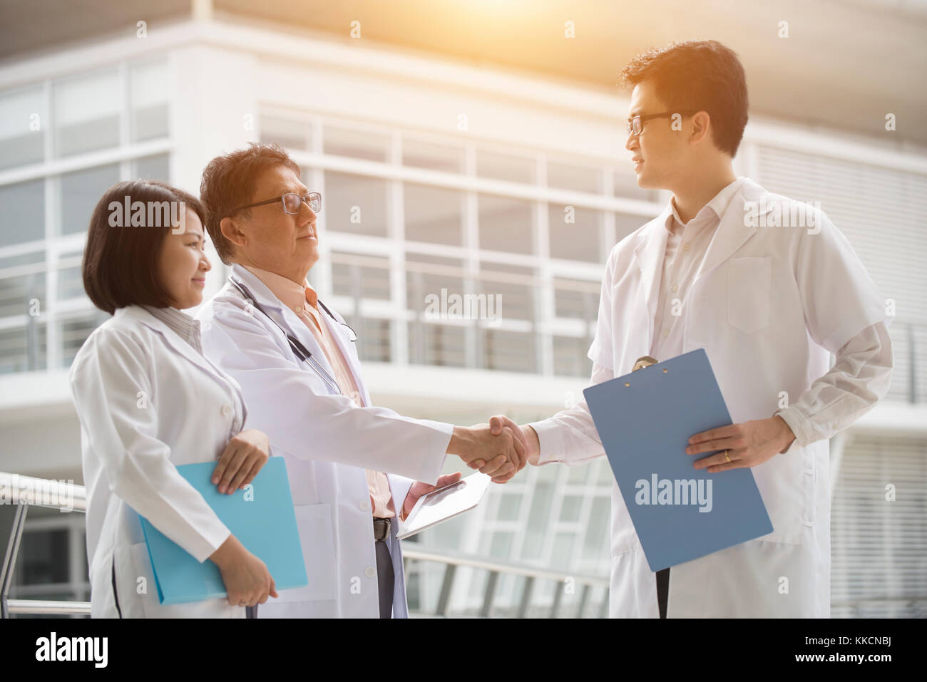 asian medical team handshaking Stock Photo - Alamy