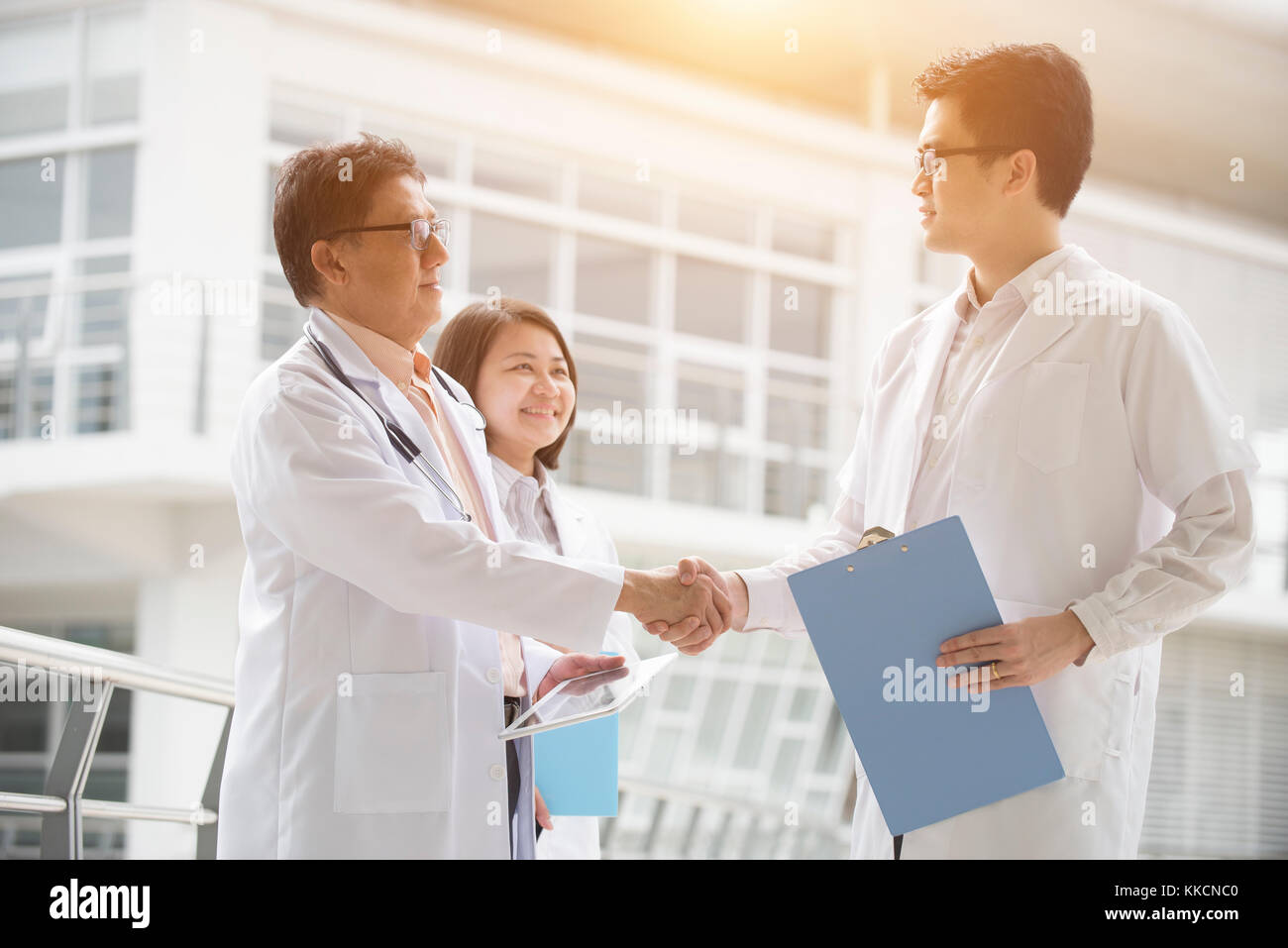 asian medical team handshaking Stock Photo - Alamy