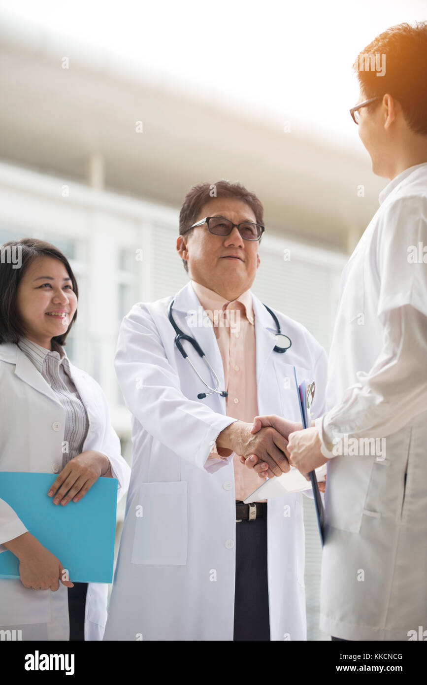 asian medical team handshaking Stock Photo - Alamy