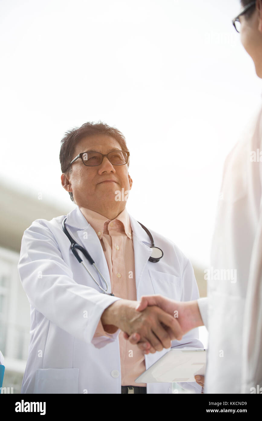 asian medical team handshaking Stock Photo - Alamy