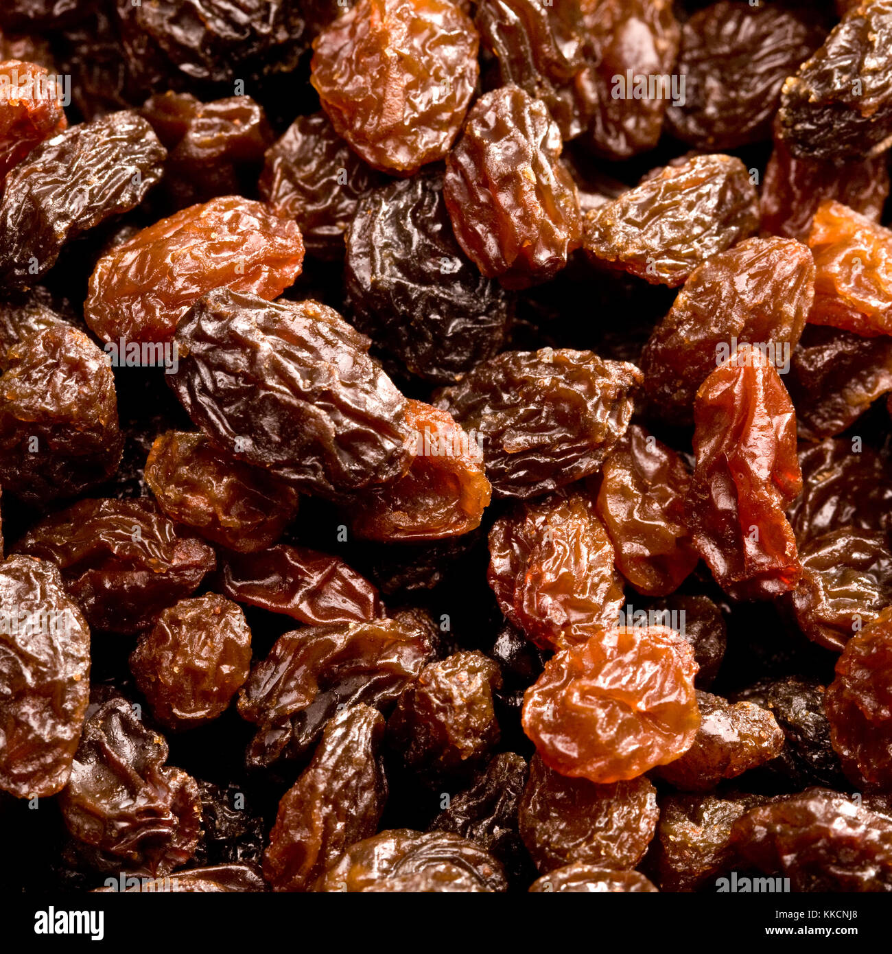 Brown raisins close up background Stock Photo - Alamy