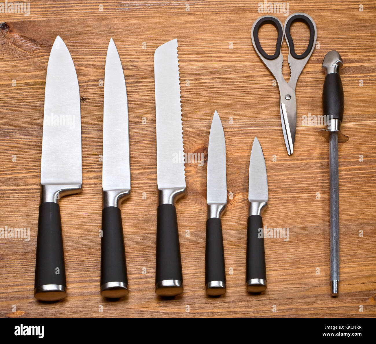 Collection of kitchen knives isolated on wooden background Stock Photo ...