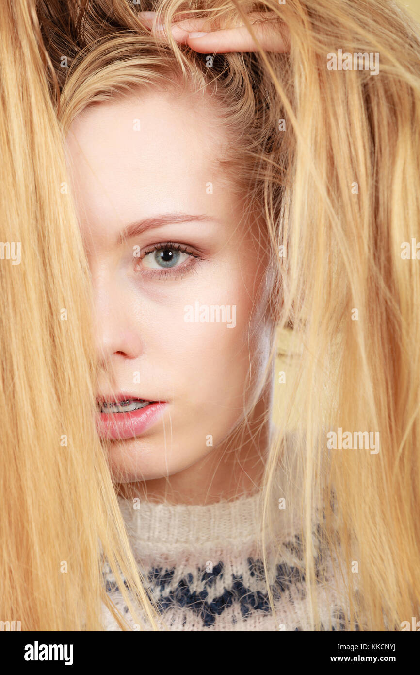 Haircare, hairstyling, bleaching concept. Blonde woman holding her long ...