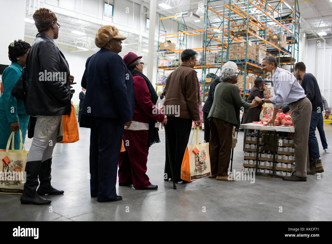 President Barack Obama talks with people as he and members of the Obama ...