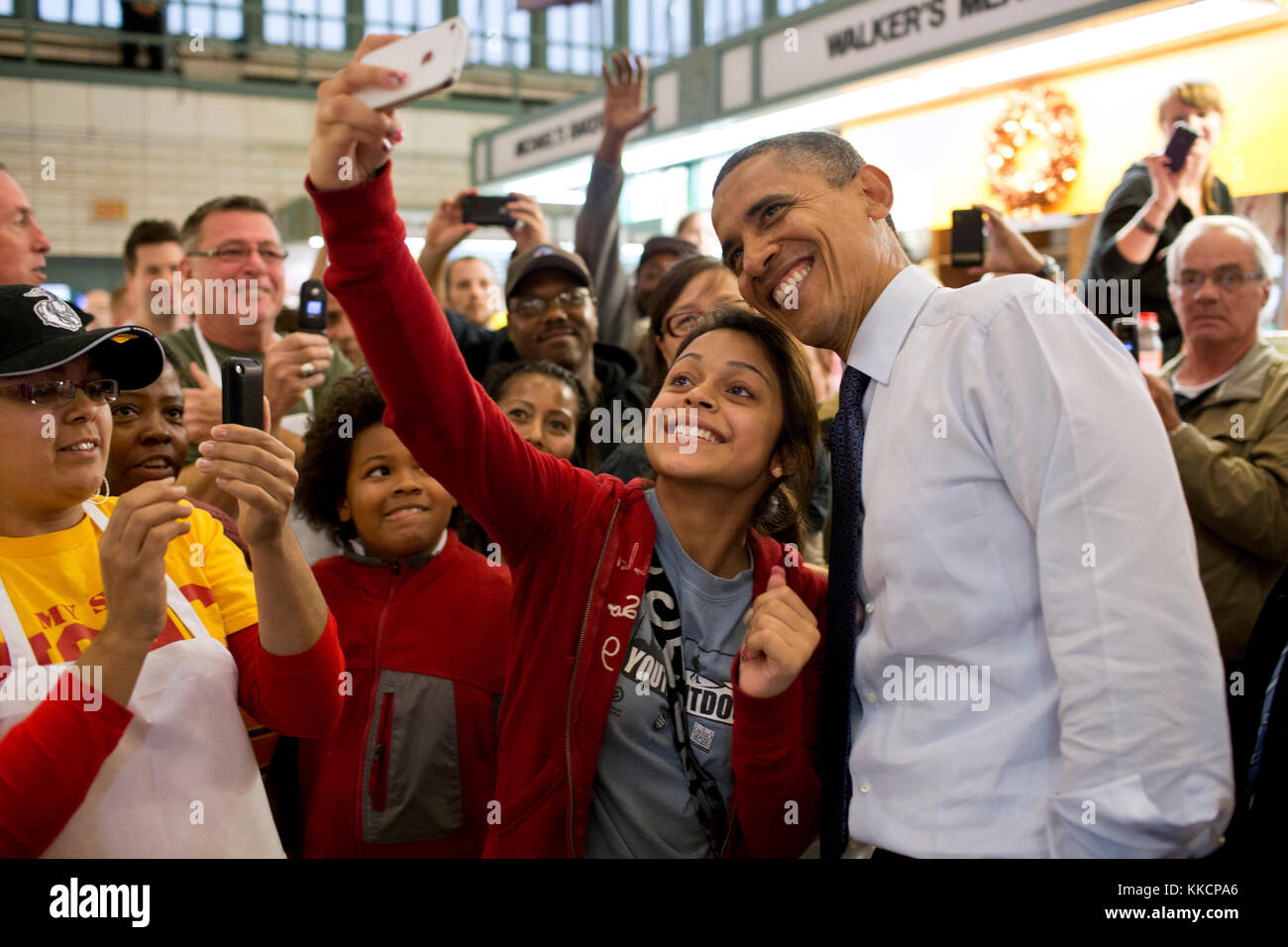 President Barack Obama has his picture taken with a patron at the West ...