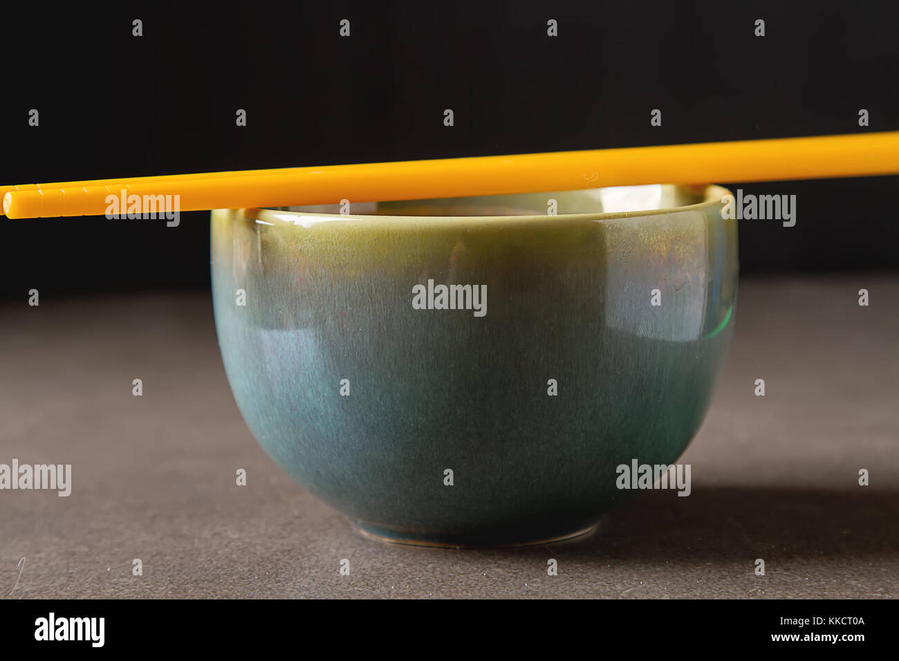 Chinese food. Two chopsticks for eating. Food sticks. Dark background ...