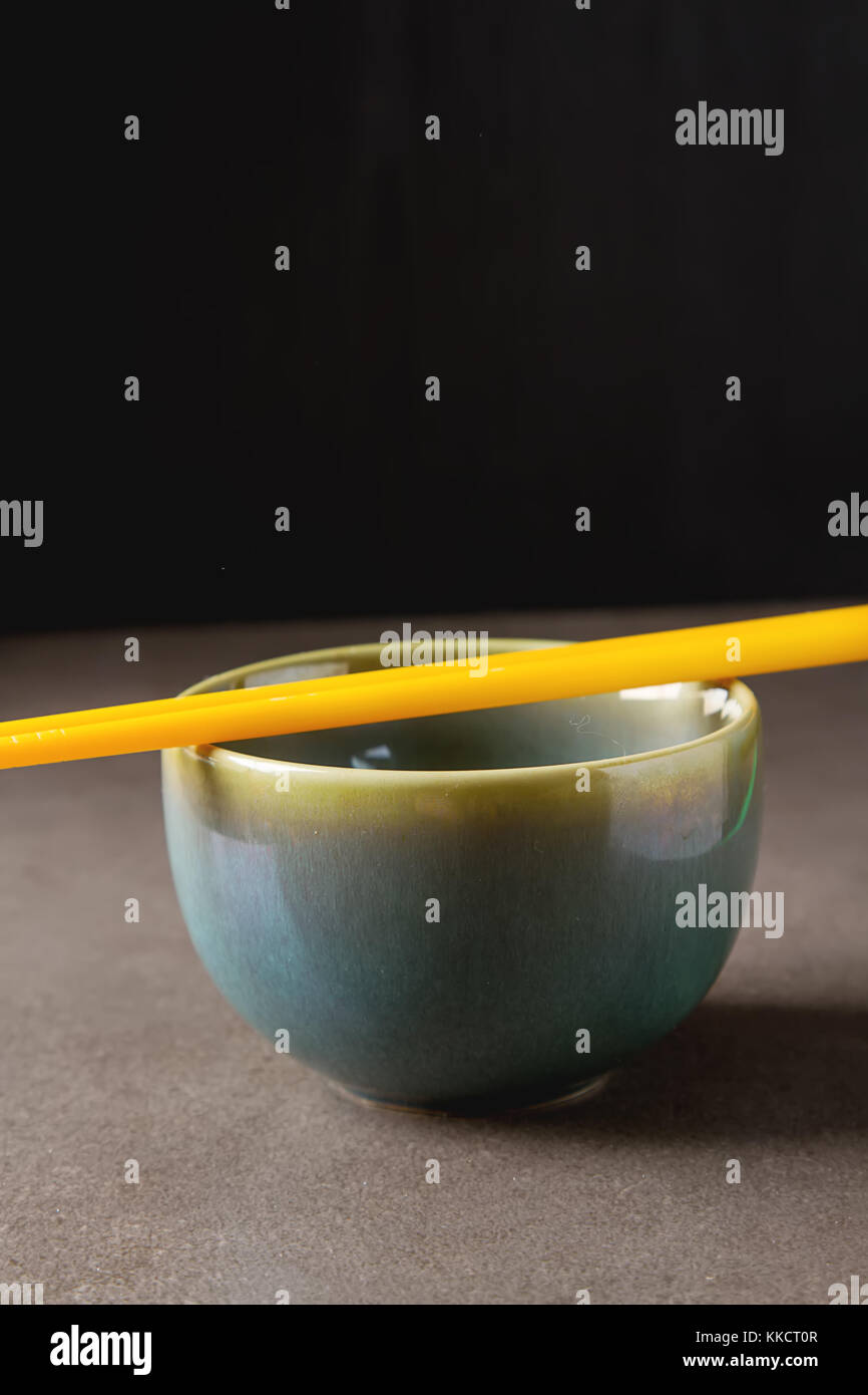 Chinese food. Two chopsticks for eating. Food sticks. Dark background ...