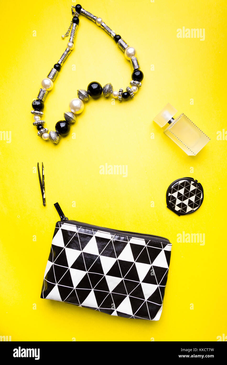 Woman handbag with makeup and accessories on yellow background. Flat ...