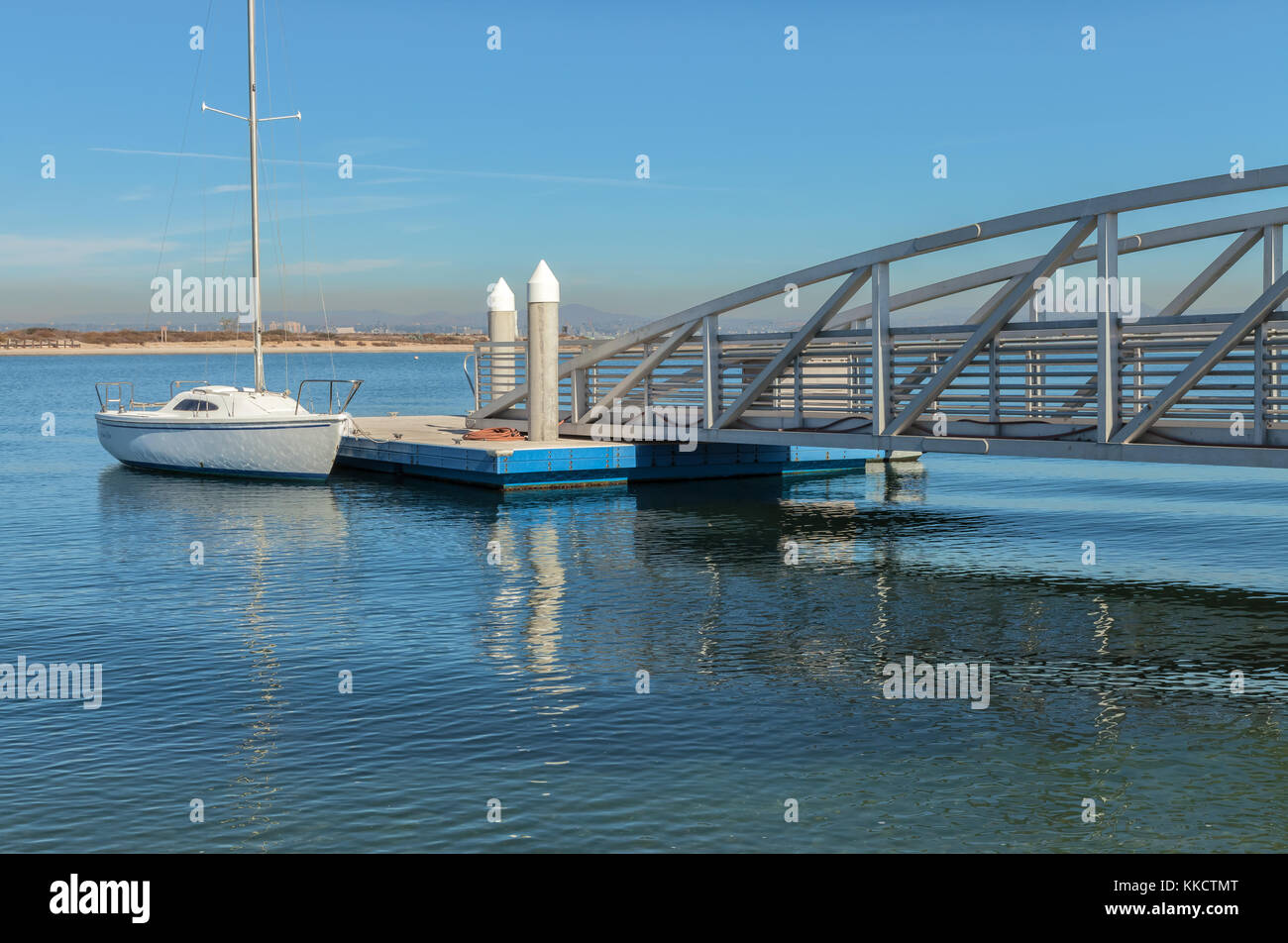 Small bridge connecting to a dock with docked boat, Coronado Bay ...