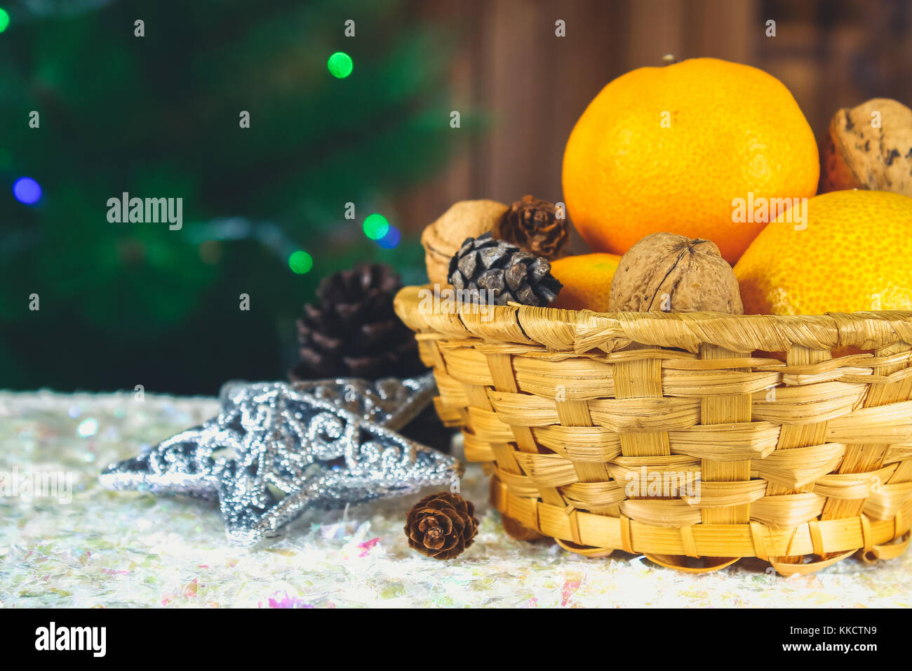 Mandarins, walnuts and bumps in a basket on the background of a ...