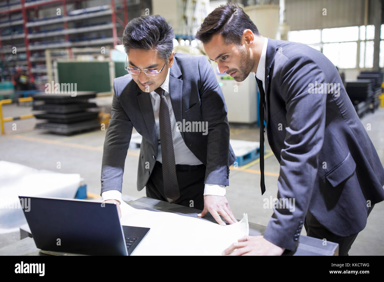 Businessman and engineer talking in the factory Stock Photo - Alamy