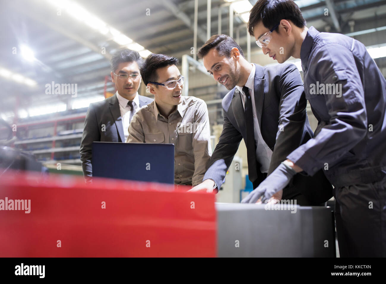 Businessmen and engineers talking in the factory Stock Photo - Alamy