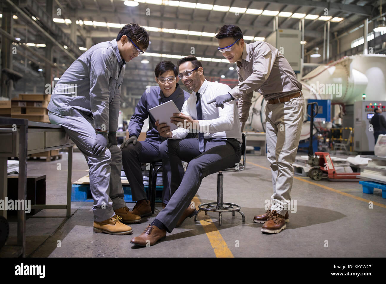 Businessman and engineers talking in the factory Stock Photo - Alamy