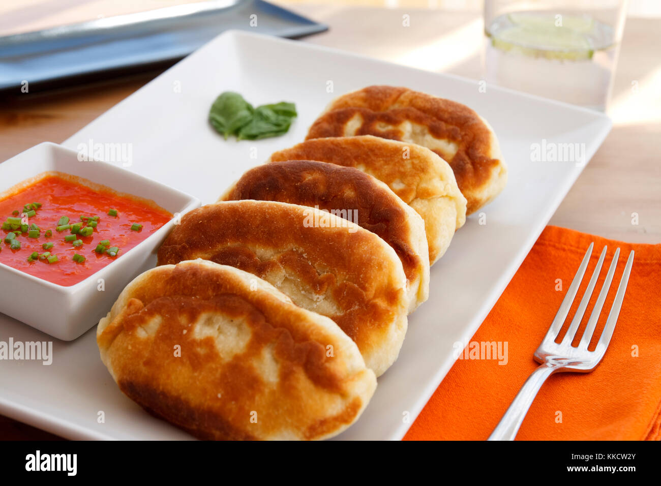 Polish dumplings with sauce Stock Photo - Alamy