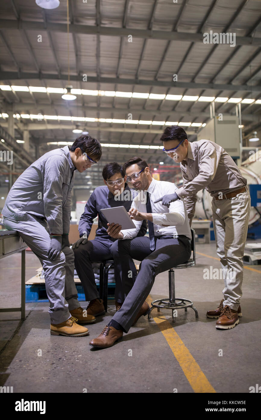 Businessman and engineers talking in the factory Stock Photo - Alamy