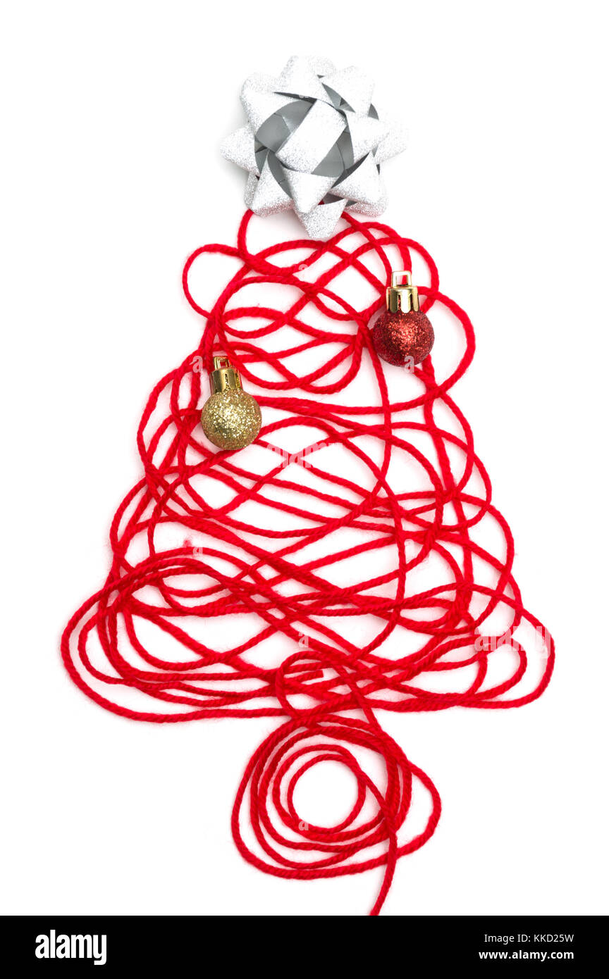 A tree made of red thread and ribbon, ball on white background Stock ...