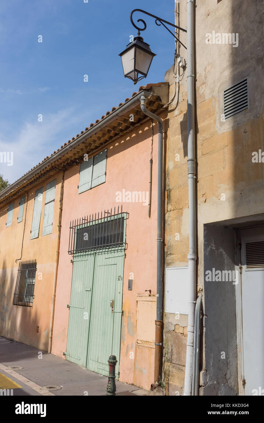 Old coral, tan and pale orange stucco buildings with wooden shutters ...