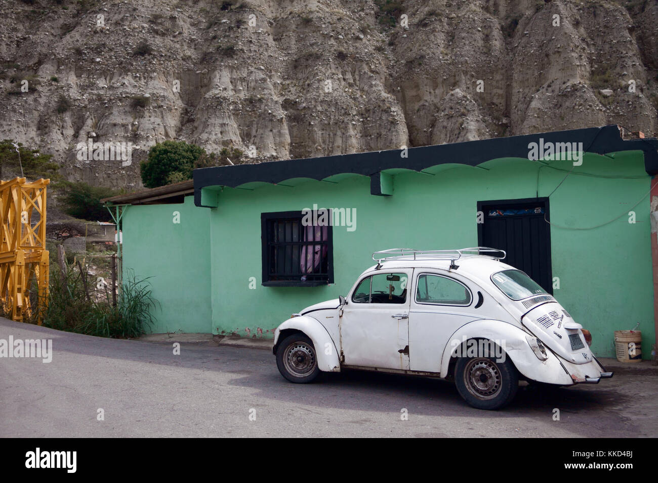 VENEZUELA, 22 NOVEMBER 2010: Old white Volkswagen beetle next to rustic ...