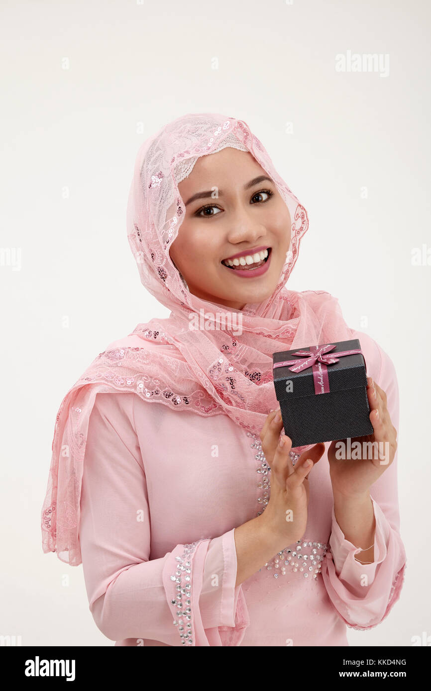 malay woman with tudung holding a present Stock Photo - Alamy