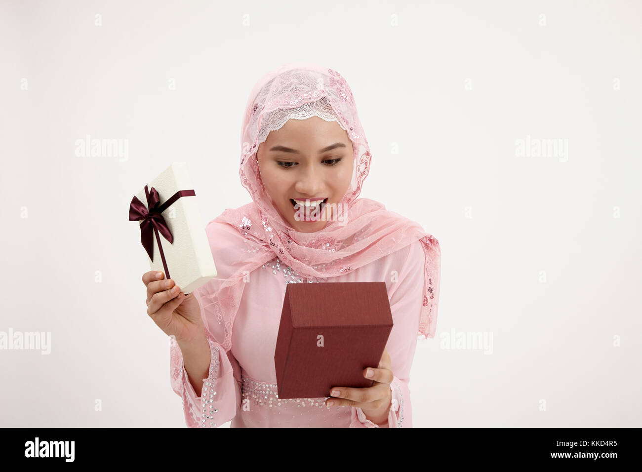 malay woman with tudung holding a present Stock Photo - Alamy