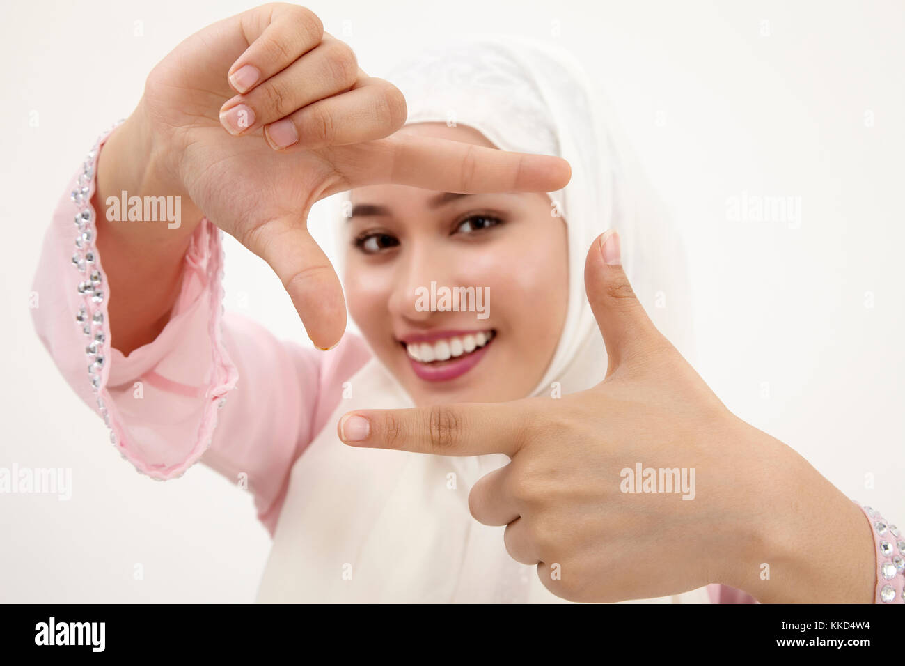 malay woman with tudung with hands showing cropping composition gesture ...