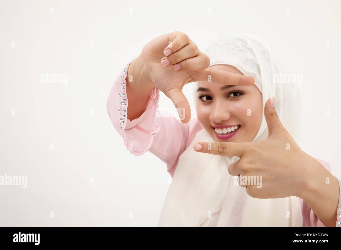 malay woman with tudung with hands showing cropping composition gesture ...