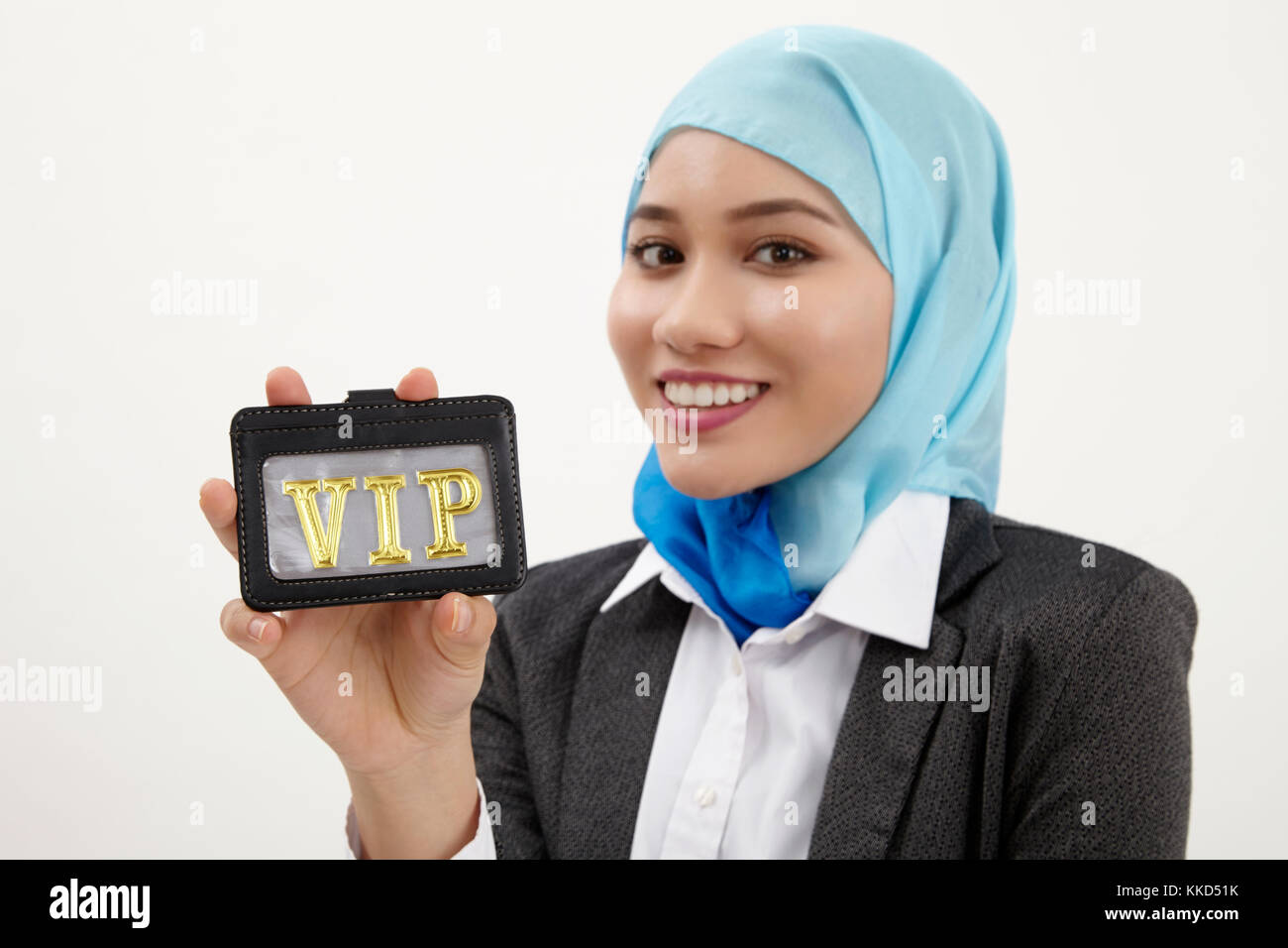 malay business woman holding a vip pass card Stock Photo - Alamy