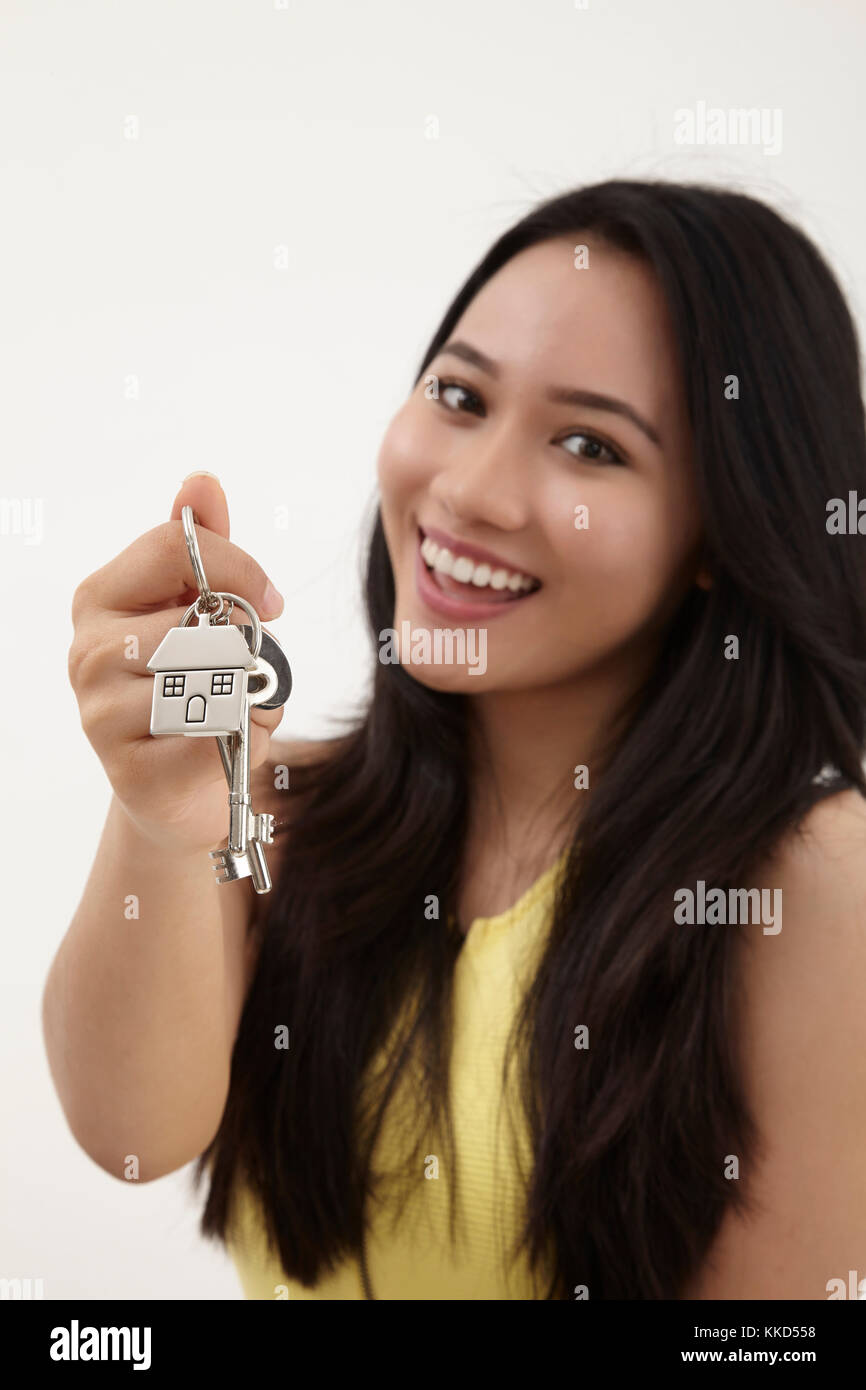 malay young woman holding house shaped key chain Stock Photo - Alamy