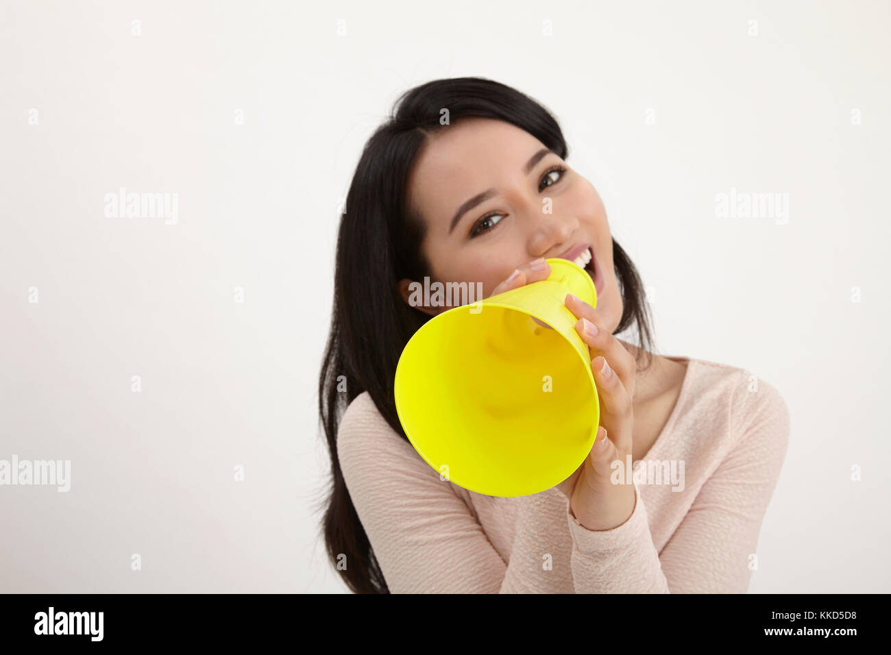 malay woman using megaphone on the white background Stock Photo - Alamy
