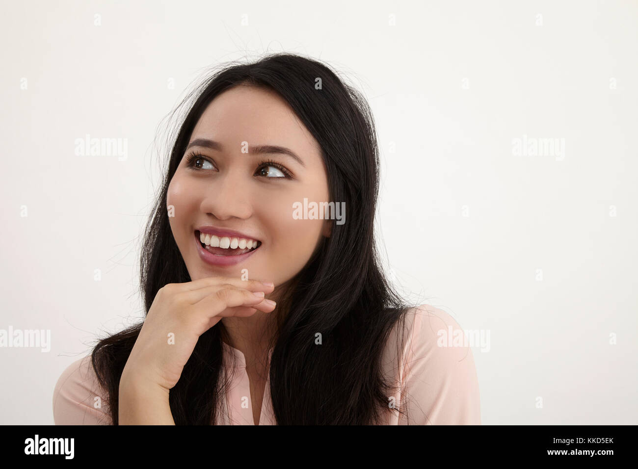Portrait of a smiling thinking woman looking up - isolated on white ...