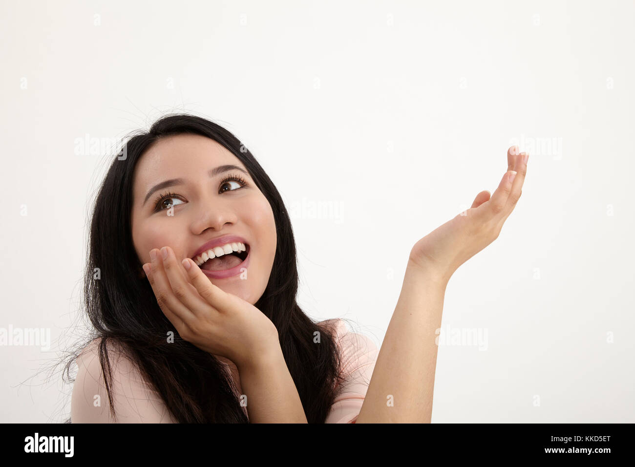 Portrait of a smiling thinking woman looking up - isolated on white ...