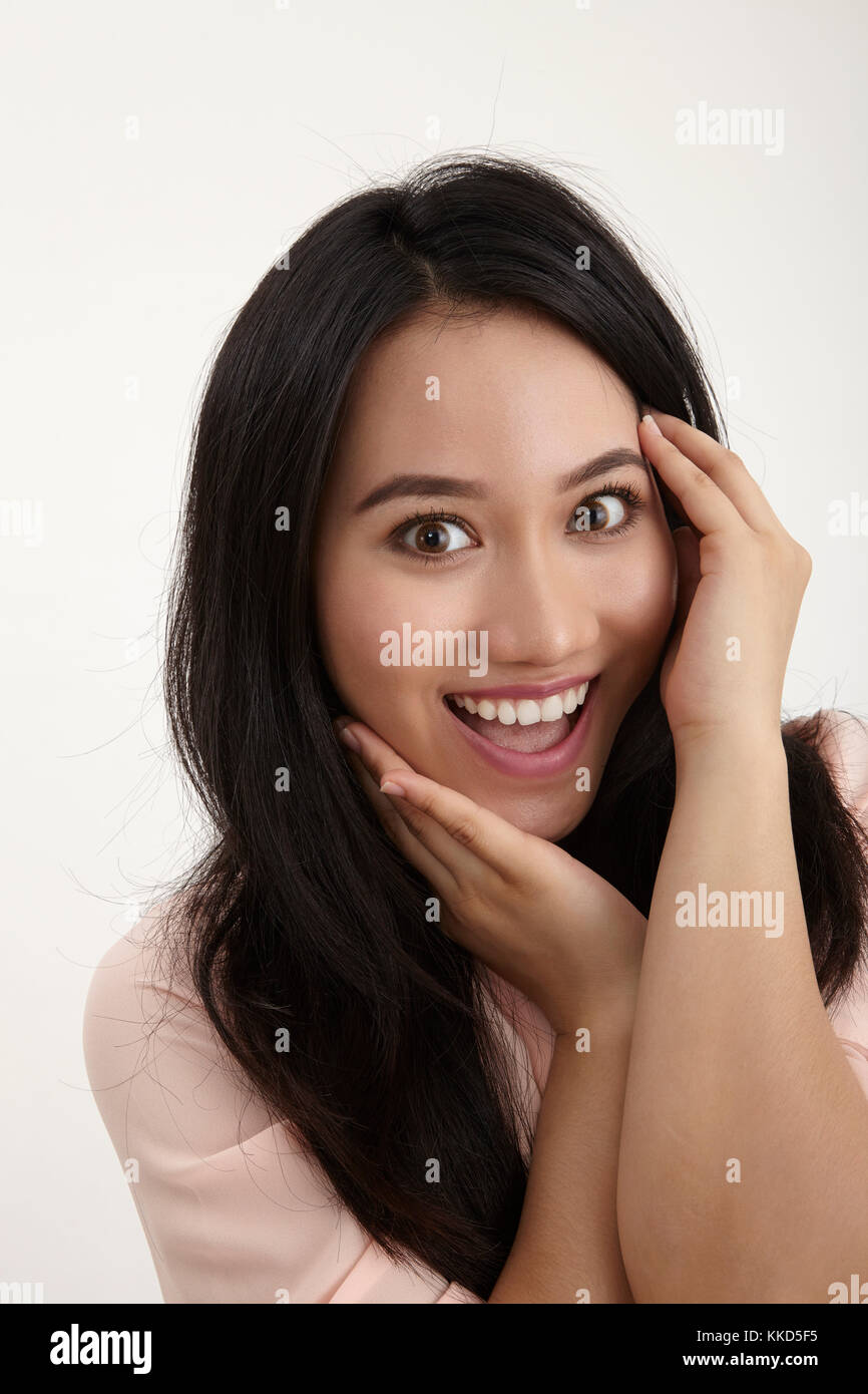 portrait of malay woman looking at camera with hand around face Stock ...