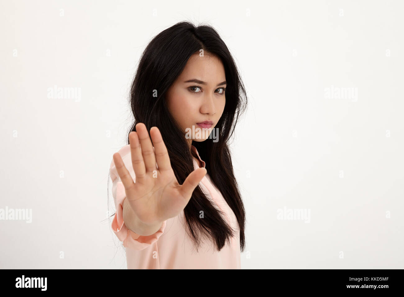 Malay woman making stop sign on white background,focus on the woman Stock Photo - Alamy