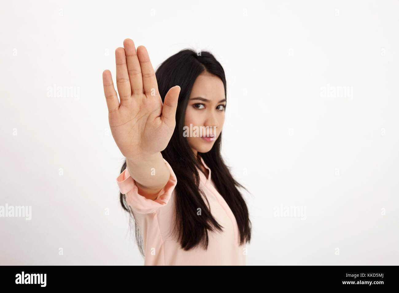 Malay woman making stop sign on white background,focus on the palm Stock Photo - Alamy