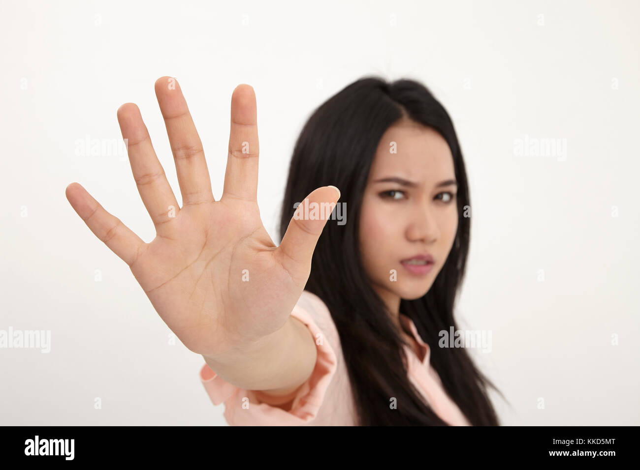 Malay woman making stop sign on white background,focus on the palm Stock Photo - Alamy