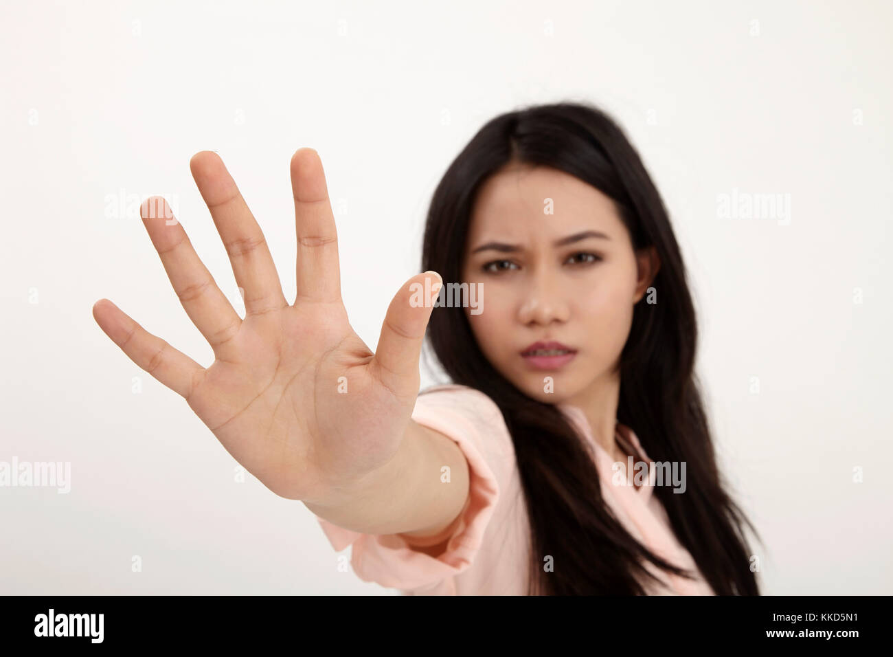 Malay woman making stop sign on white background,focus on the palm ...